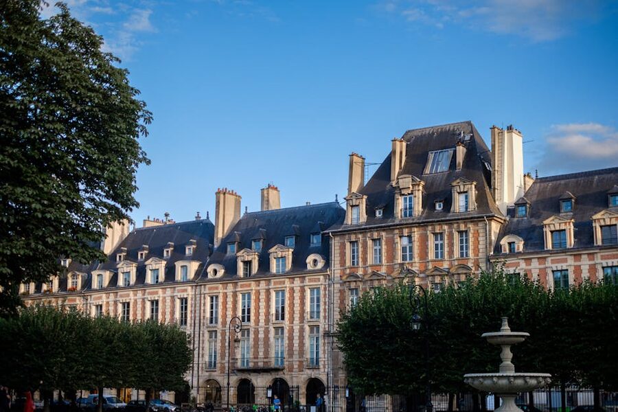 Place des Vosges classic Parisian architecture under blue sky