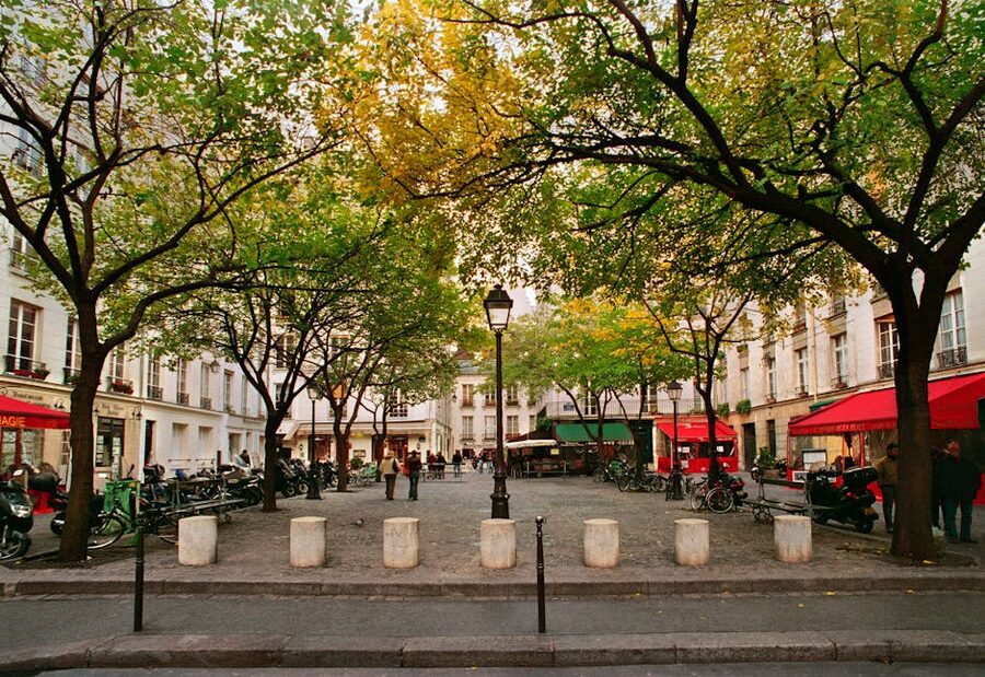 Place des Vosges autumn cafes scene with bare trees Paris Marais
