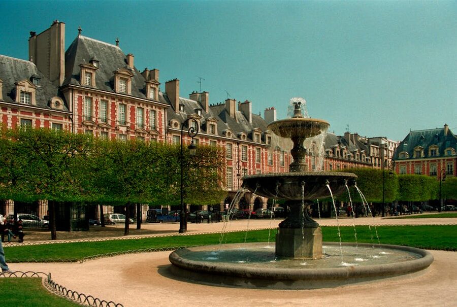 Place des Vosges fountain in Paris Marais on a clear day