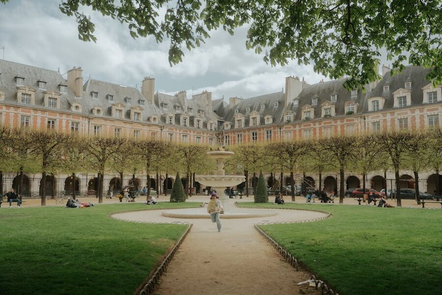 Place des Vosges with people enjoying leisure time in Paris Marais