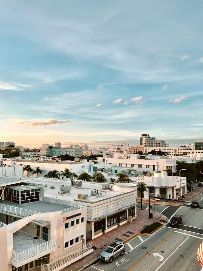 Miami Beach Art Deco buildings under a sunset sky