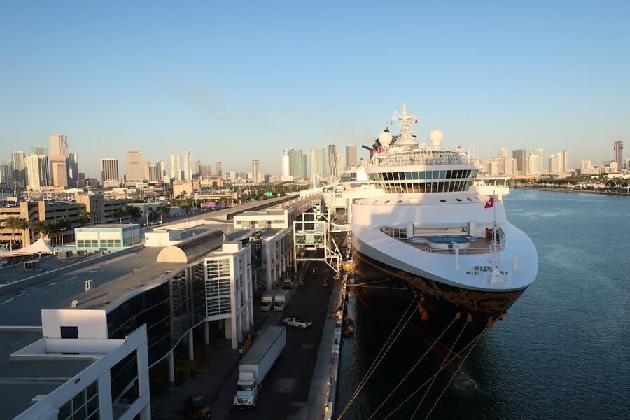 A cruise ship moored at the Port of Miami with the city skyline behind