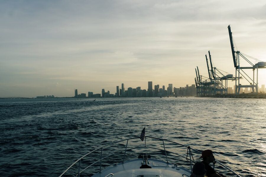 Miami downtown skyline and Port of Miami cranes seen from a boat deck