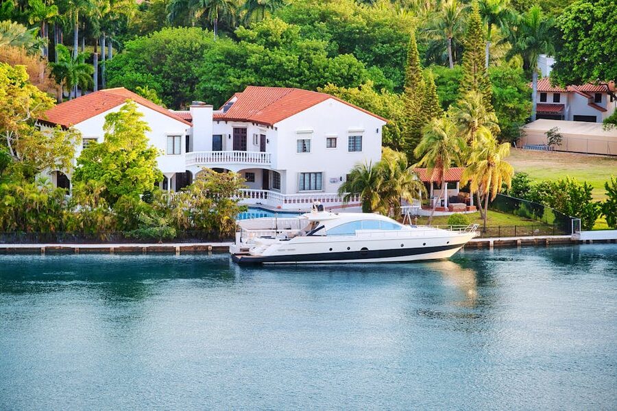 Miami waterfront mansion with a docked yacht