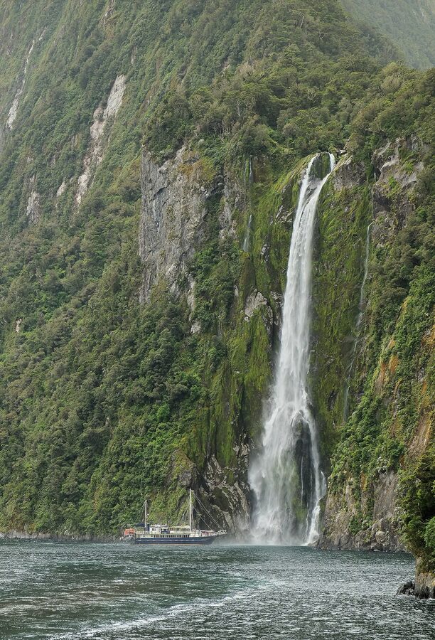 Tour boat below Stirling Falls in Milford Sound