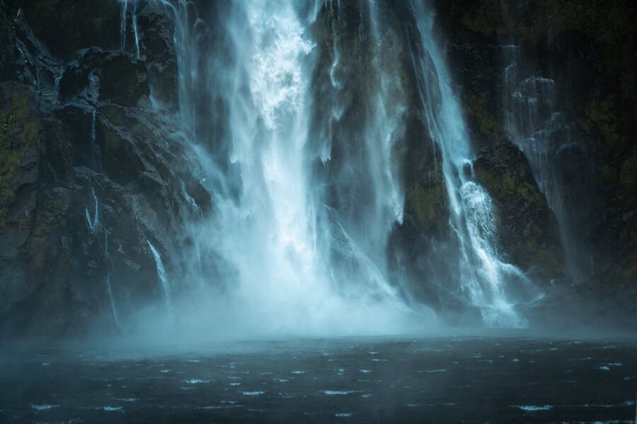 Waterfall in mist down a Milford Sound cliff