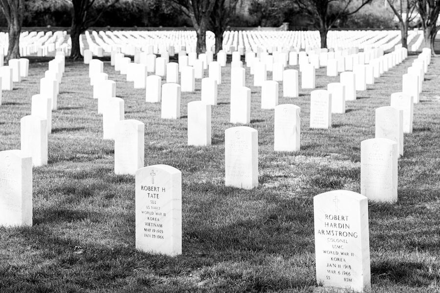 Black and white image of military cemetery with rows of headstones