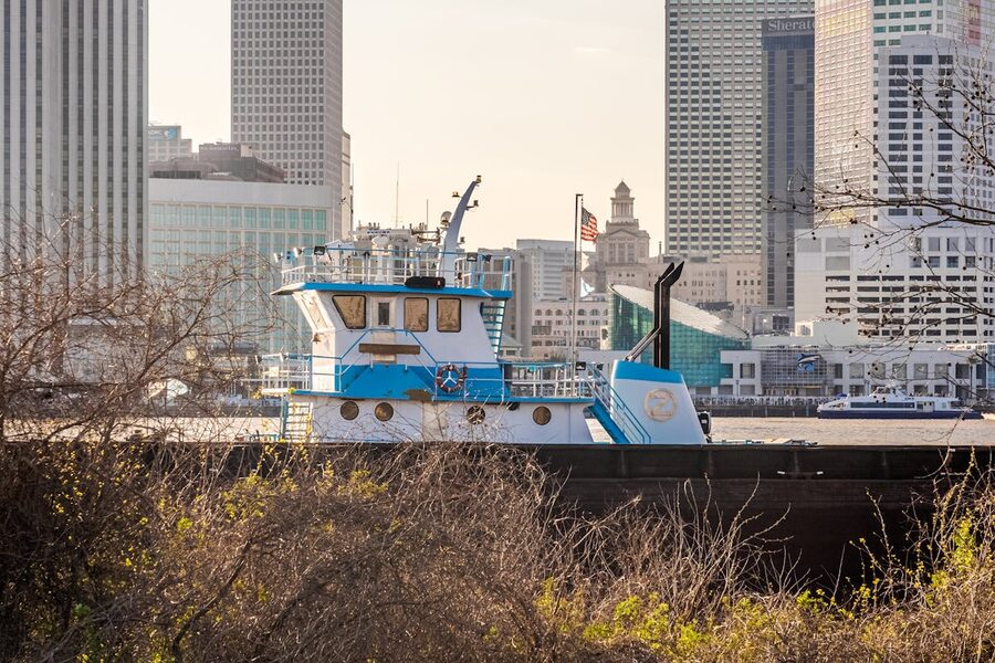Tugboat on the Mississippi River with New Orleans city skyline in background