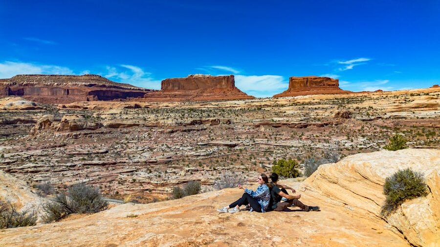 Couple overlooking the desert canyon landscape in Moab Utah