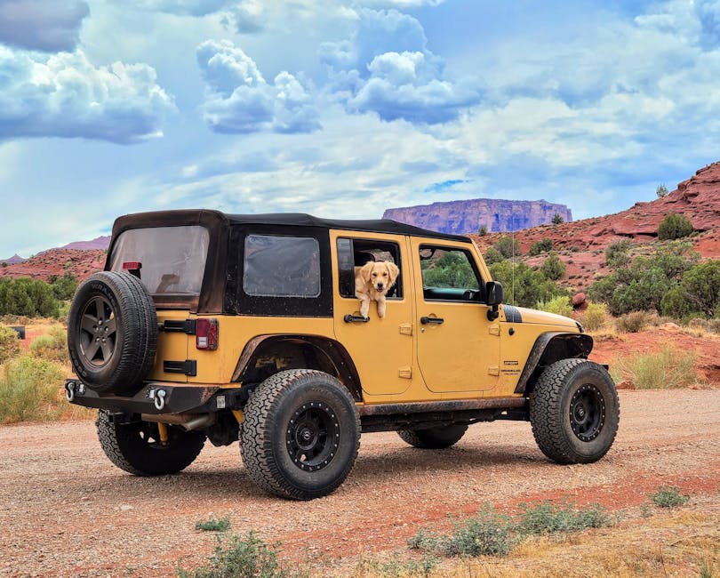 Yellow Jeep on a dirt road in Moab Utah landscape