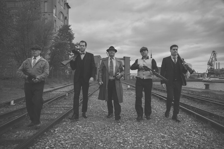 Vintage actors in gangster roles armed with weapons