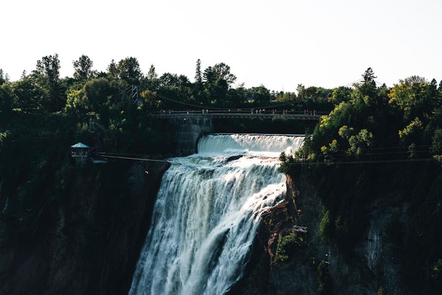Montmorency Falls in summer with pedestrian bridge and lush greenery