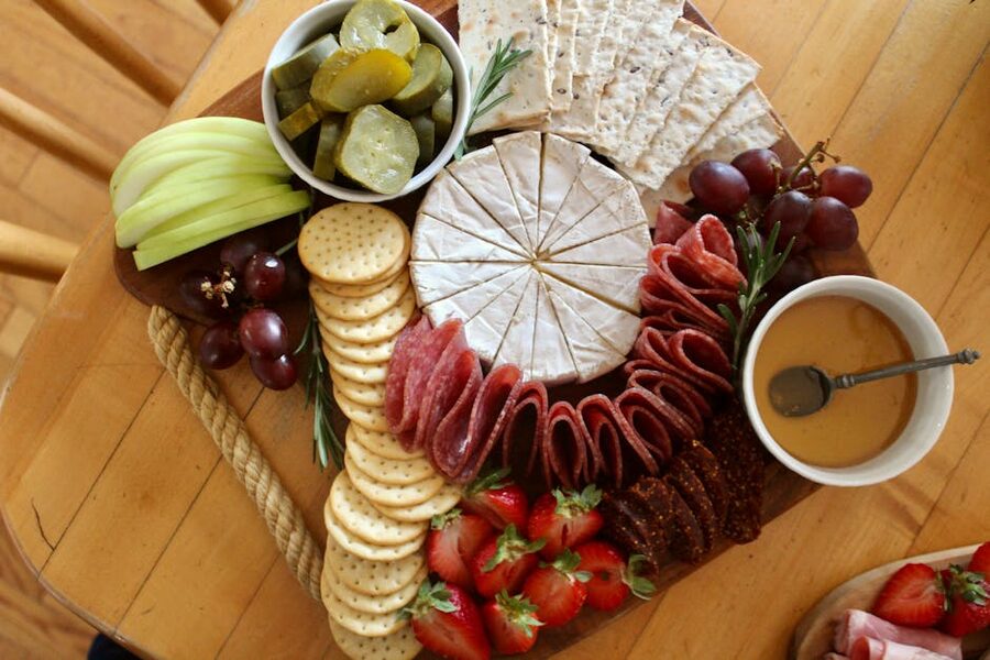 Charcuterie board with brie, salami, crackers and fruit