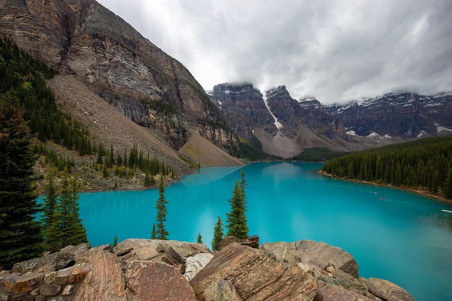 Glacial turquoise water at Moraine Lake with mountain backdrop