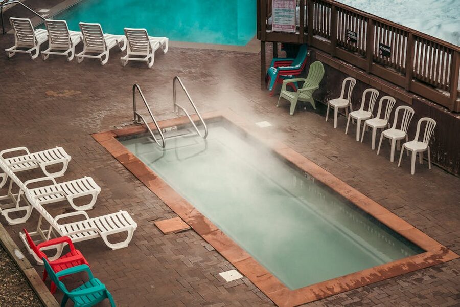 Aerial view of steaming thermal pool with sunbeds