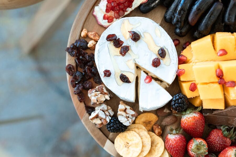 Cheese fruit grazing platter on wooden board