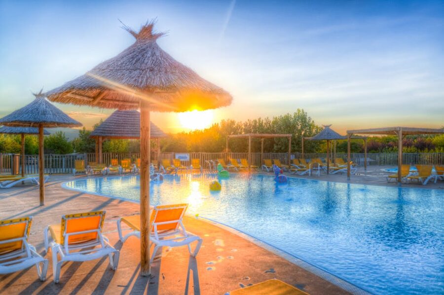 Resort lounge chairs at sunset