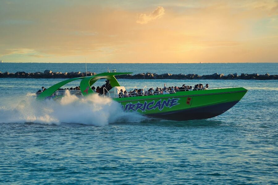 Motor yacht speeding across ocean waves at sunset