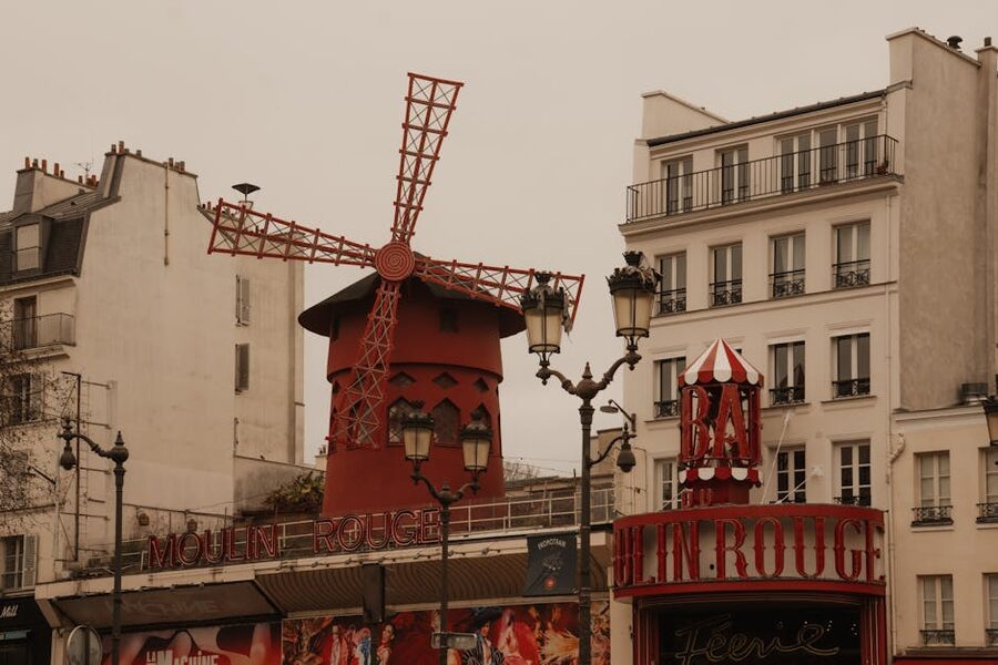 Moulin Rouge red windmill facade Montmartre Paris daytime