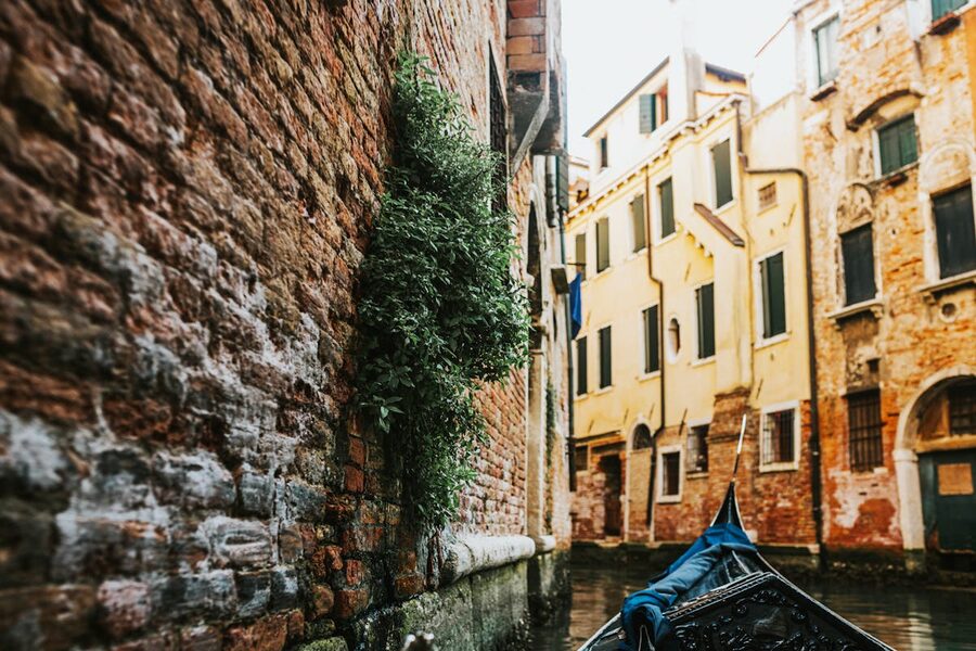 Gondola navigating Venetian canal surrounded by historic buildings