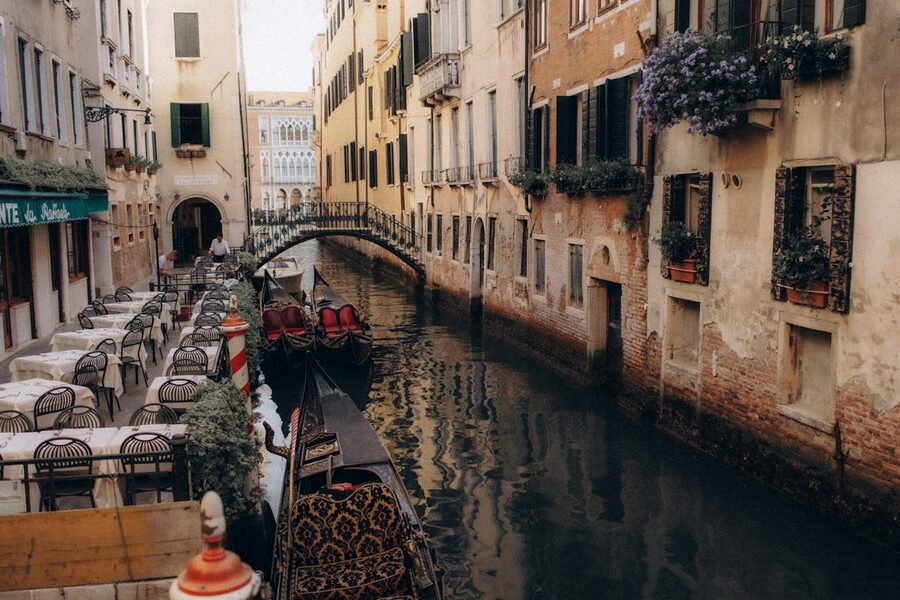 Venetian canal with gondolas and riverside cafe