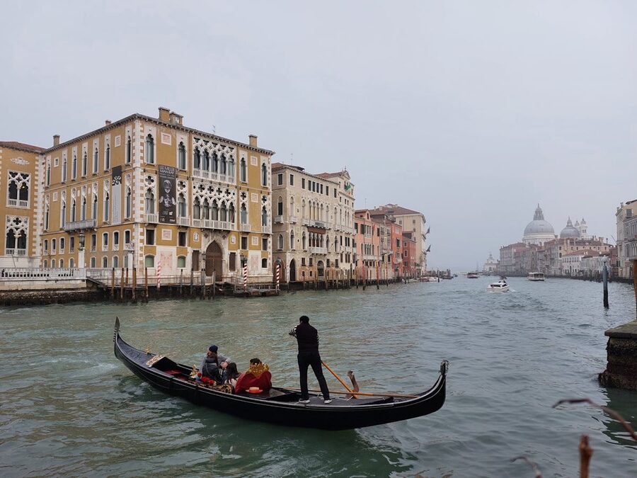Gondola ride on Grand Canal with Venetian architecture in Venice