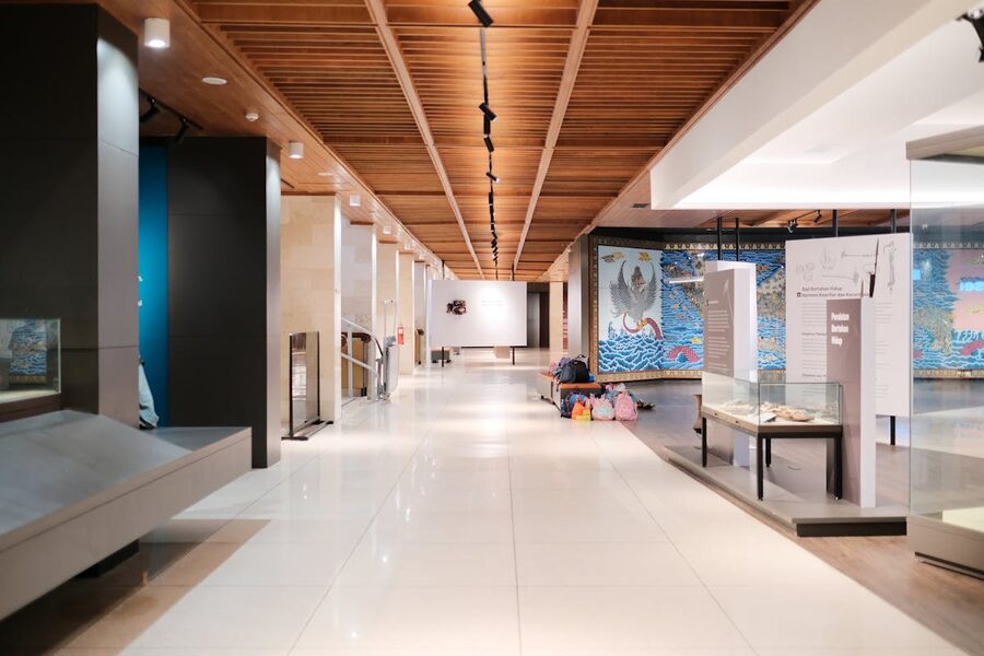 Bright museum hallway with exhibits and empty walkways