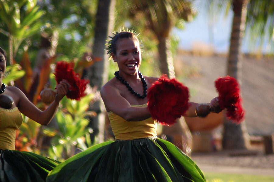 Polynesian luau dancers performing on stage during the dinner show