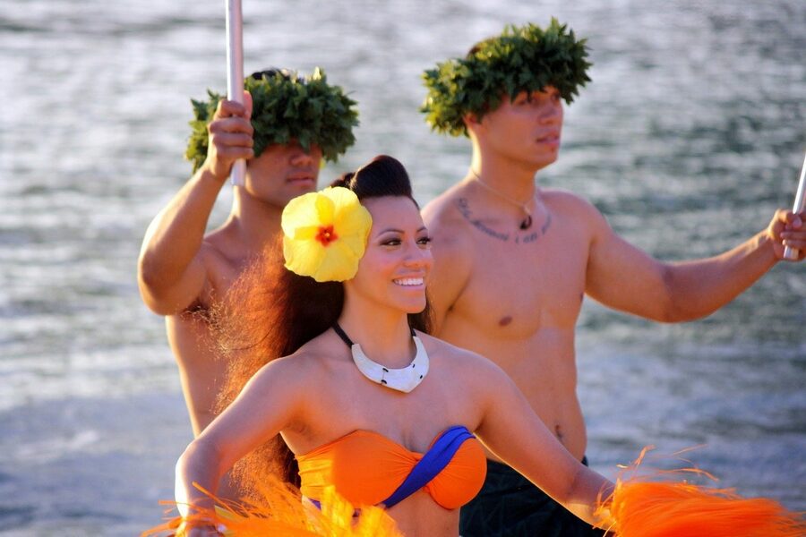 Hula dancer wearing a fresh lei at a Polynesian luau show