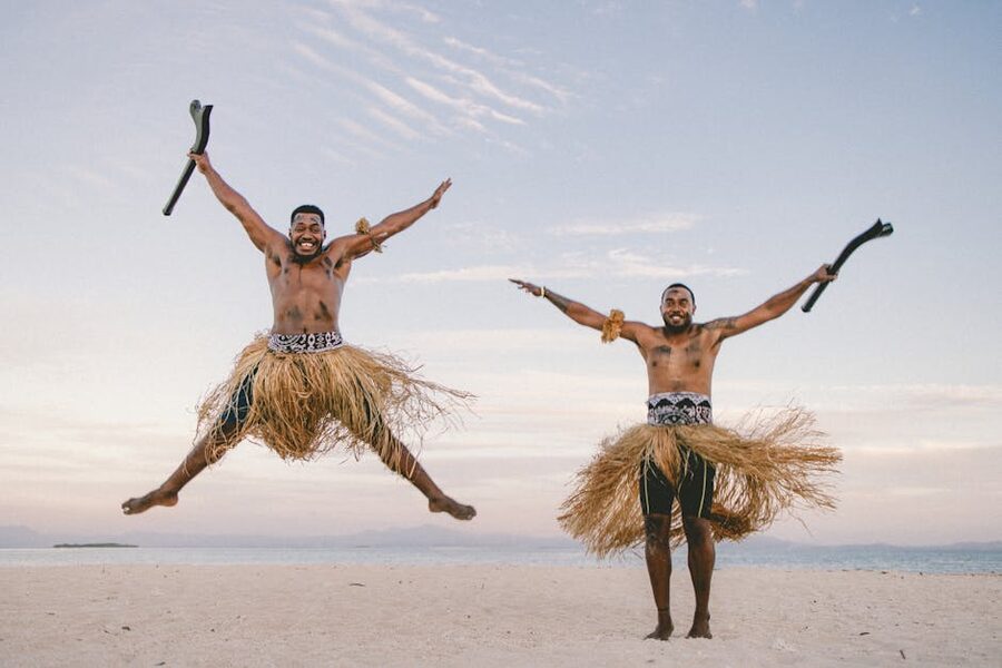 Polynesian men in traditional attire demonstrating a warrior stance