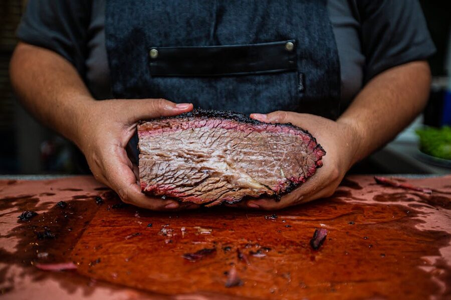 Smoked brisket sliced on wooden cutting board
