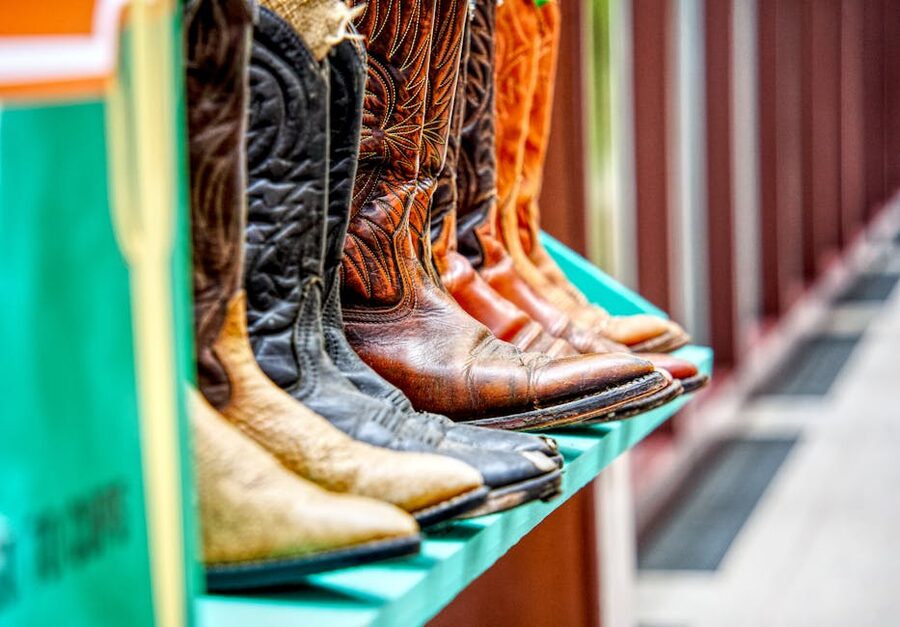 Display of leather cowboy boots on a shelf