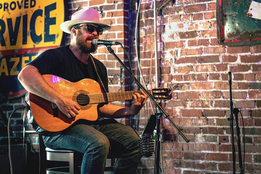Guitarist playing acoustic guitar in a Nashville bar
