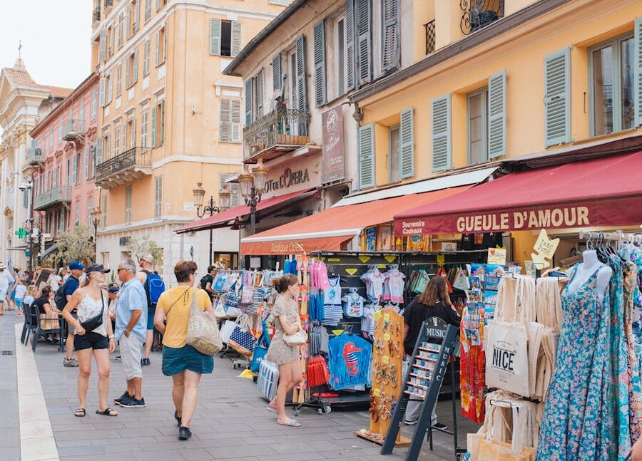 Vieux Nice street market shoppers and storefronts