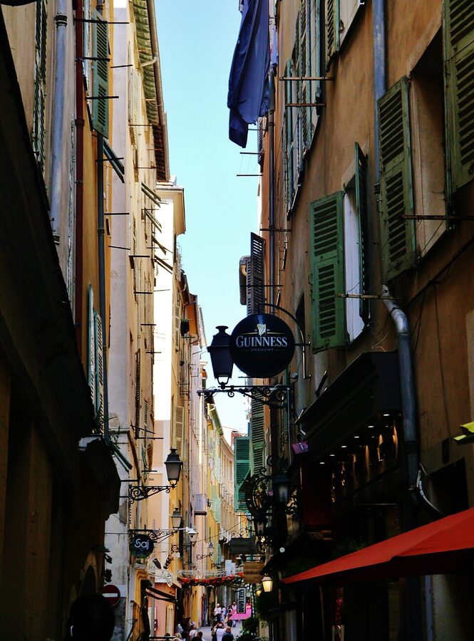 Vieux Nice ochre yellow buildings narrow street with shutters