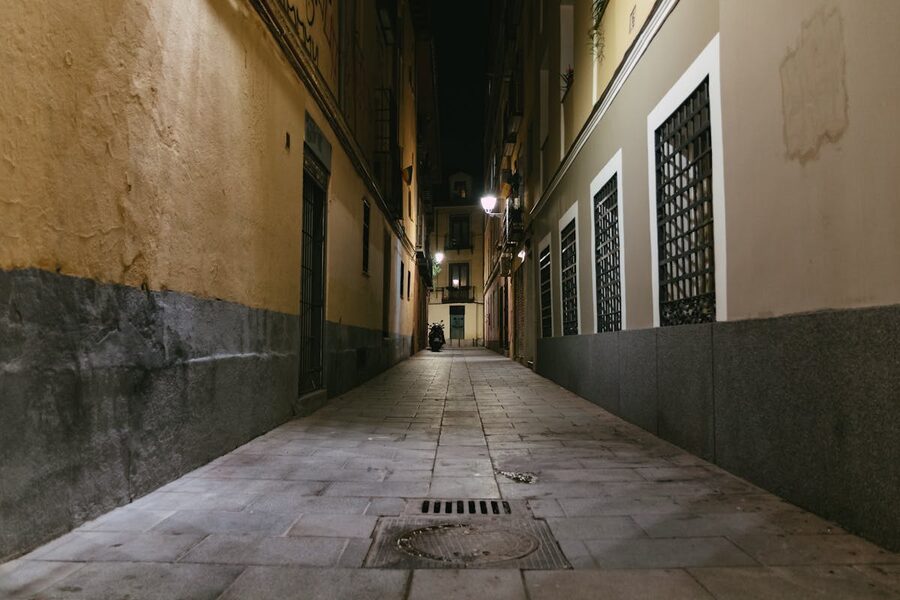 Dark urban alley with classic architecture night ambiance