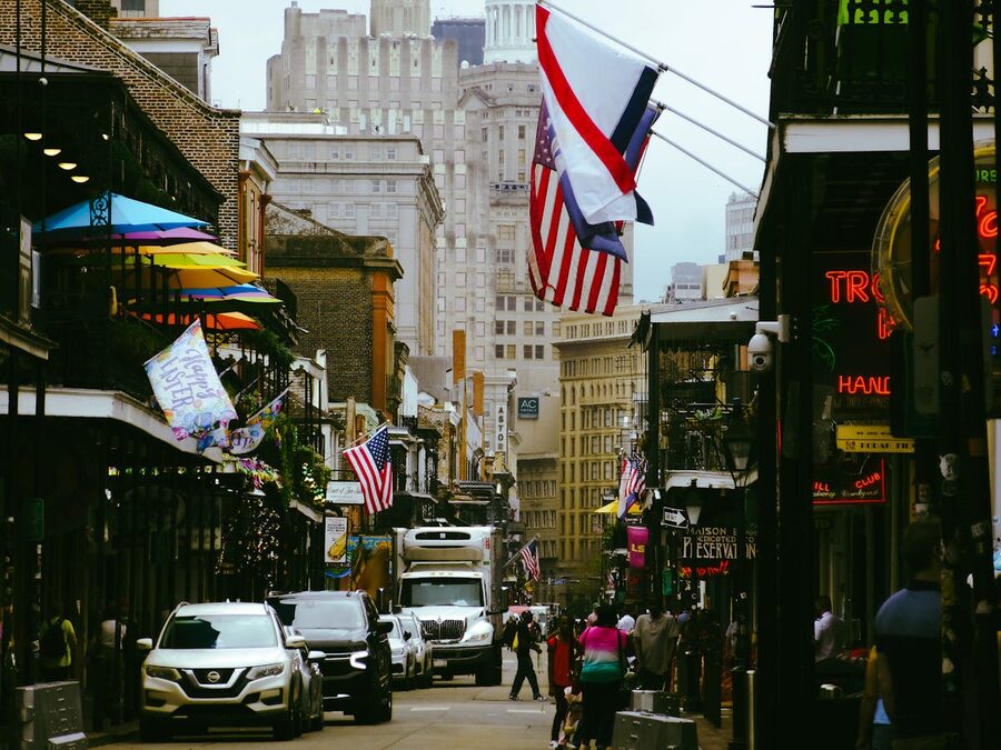 Lively street scene in New Orleans French Quarter with flags