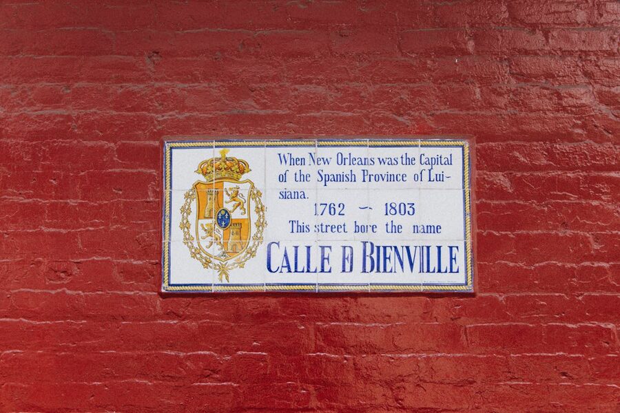 Street sign on red brick wall New Orleans Spanish era
