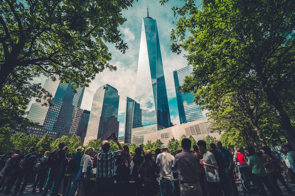 One World Trade Center surrounded by greenery and crowd