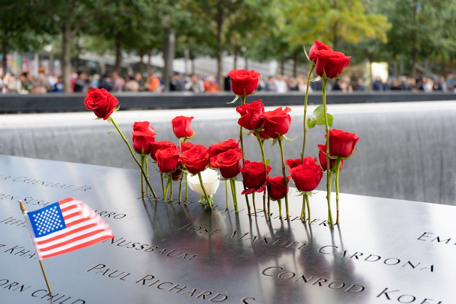 Red roses and American flag at 9/11 Memorial