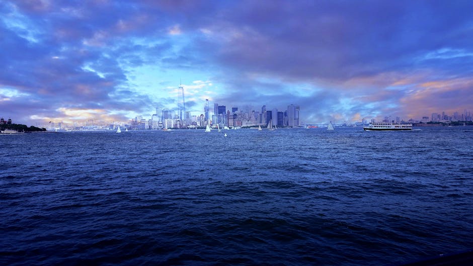 NYC skyline at dusk with sailboat