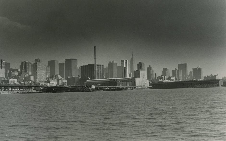 Retro black and white NYC skyline over harbor
