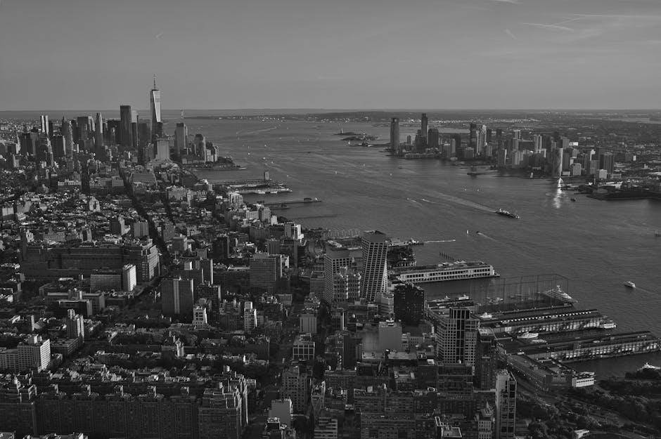 Black and white aerial NYC skyline with harbor