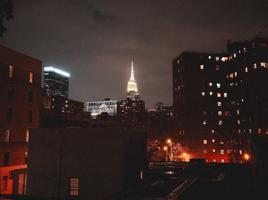 Empire State Building at night among city lights