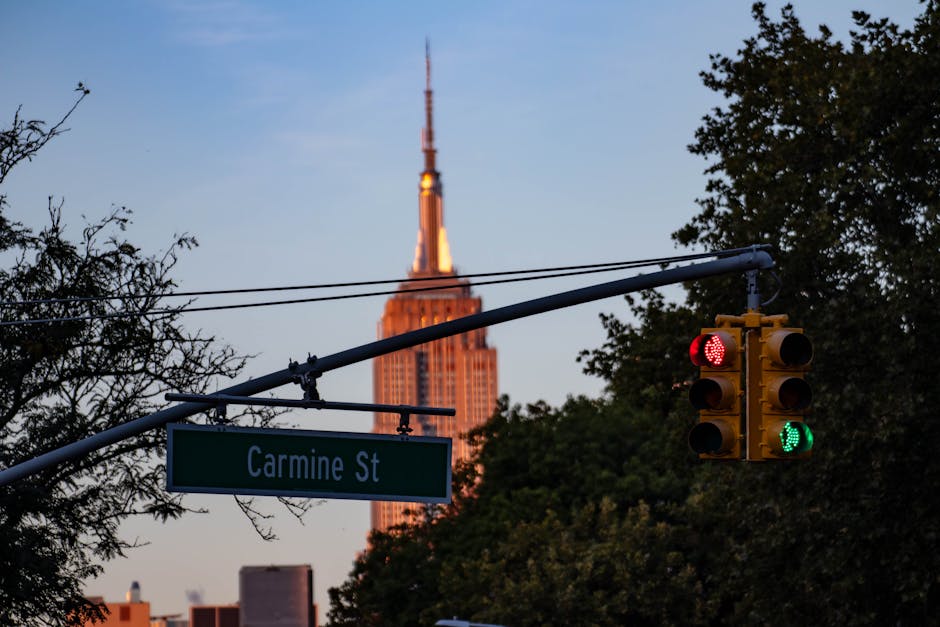 Empire State Building seen from street level with traffic lights
