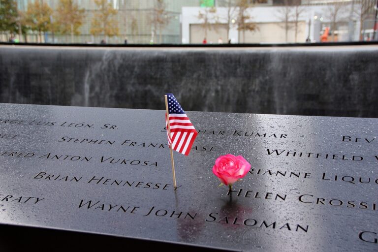 9/11 Memorial reflecting pool with One World Trade Center rising behind