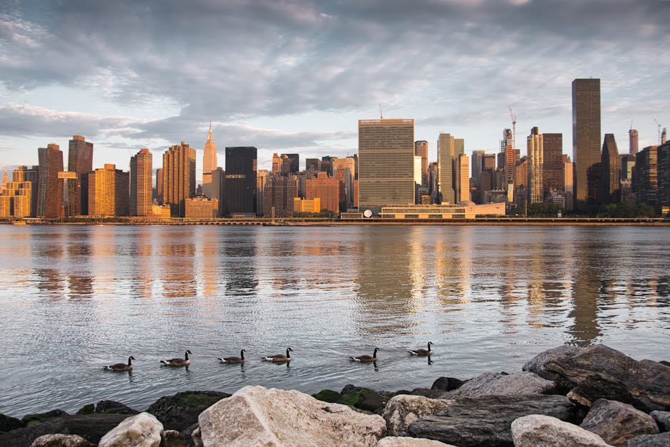NYC skyline at sunset reflected in East River