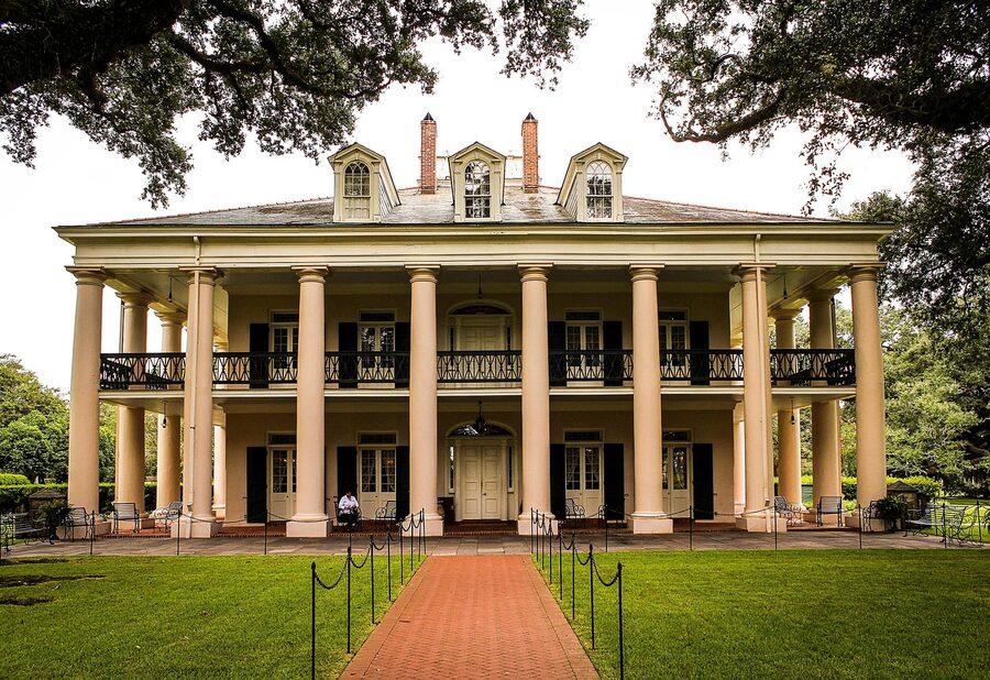 Oak Alley Plantation mansion with sugarcane fields in Louisiana