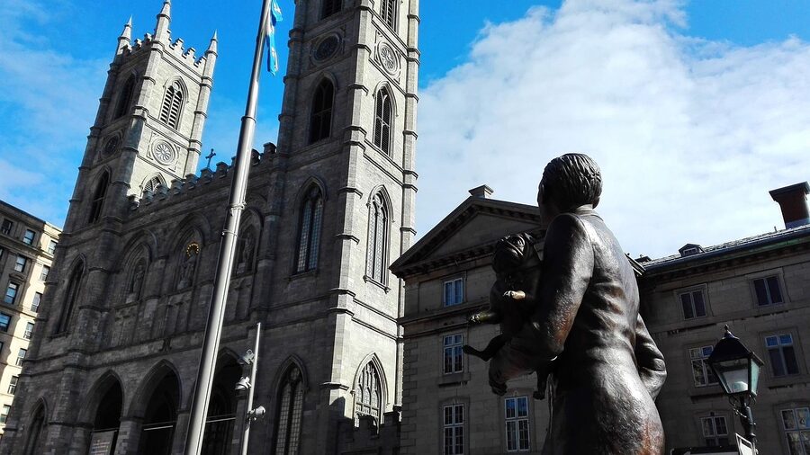 Old Montreal church with statue and stone architecture
