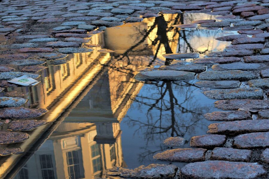 Old Montreal street puddle reflection after rain